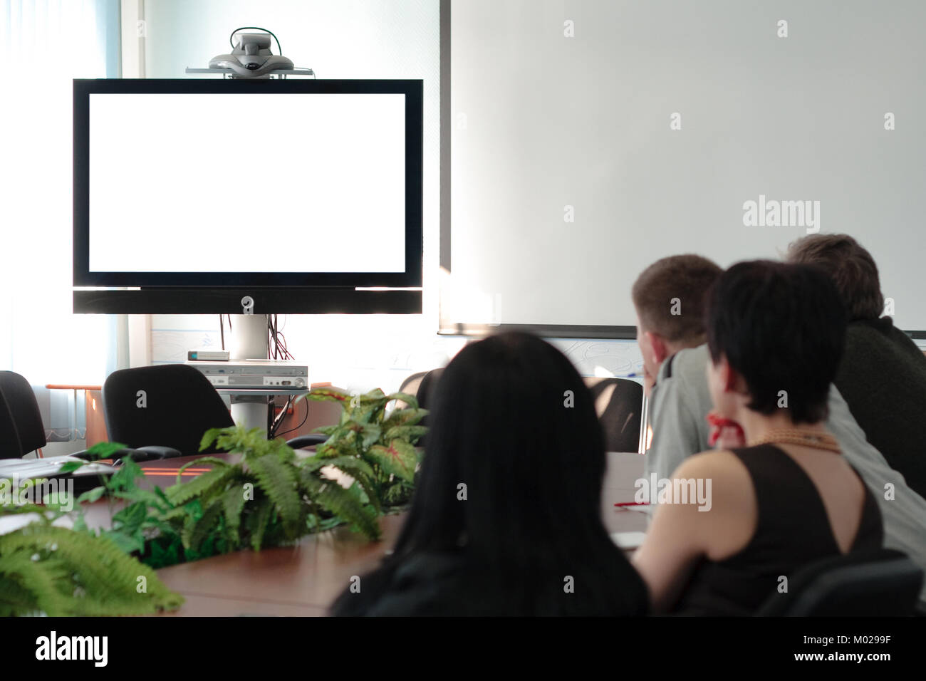 People in the office looking at the screen Stock Photo - Alamy