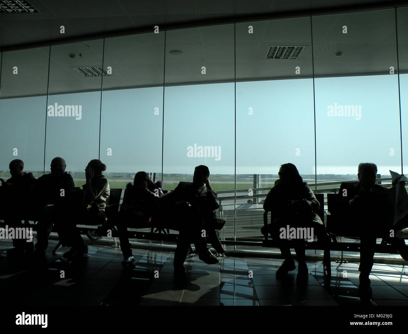 People waiting in an airport due to delays, strikes, security checks ...
