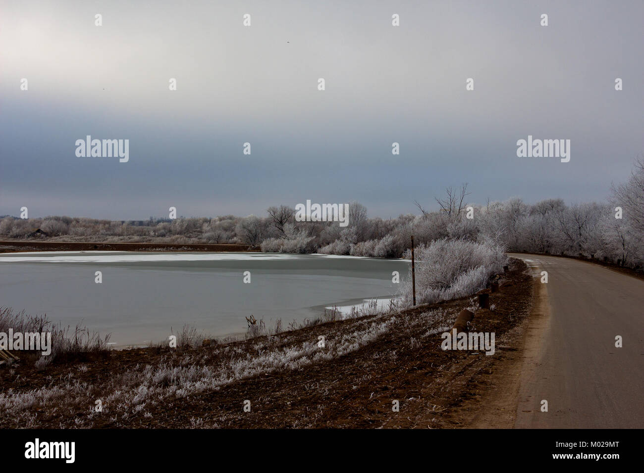 Landscape with a road and a lake Stock Photo - Alamy