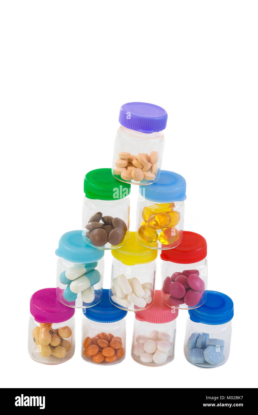 stack of Medicine Tablets in glass Box with multi colored plastic caps ...