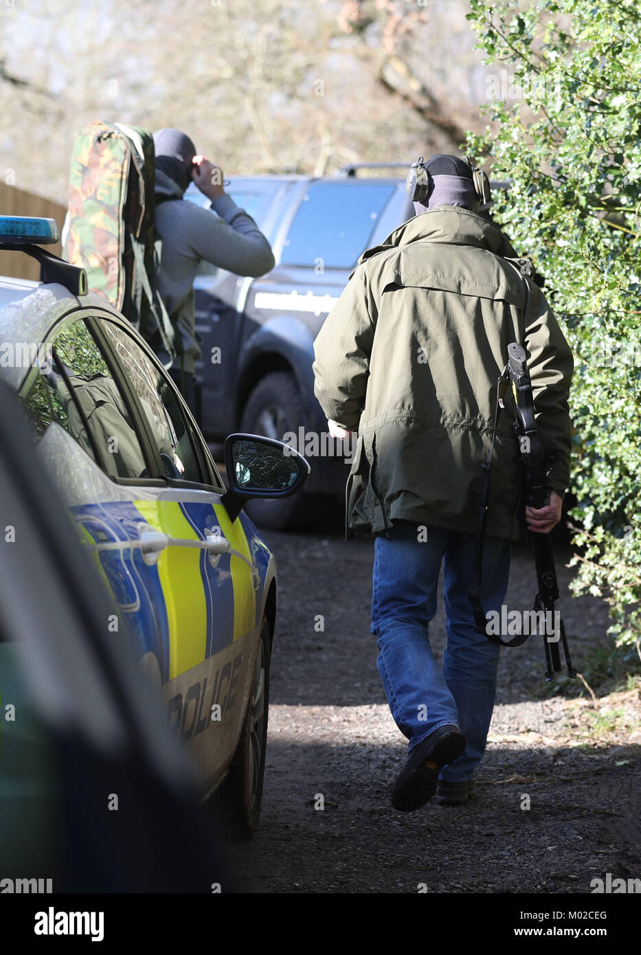 A police officer carries a weapon during the hunt for a wolf which had ...