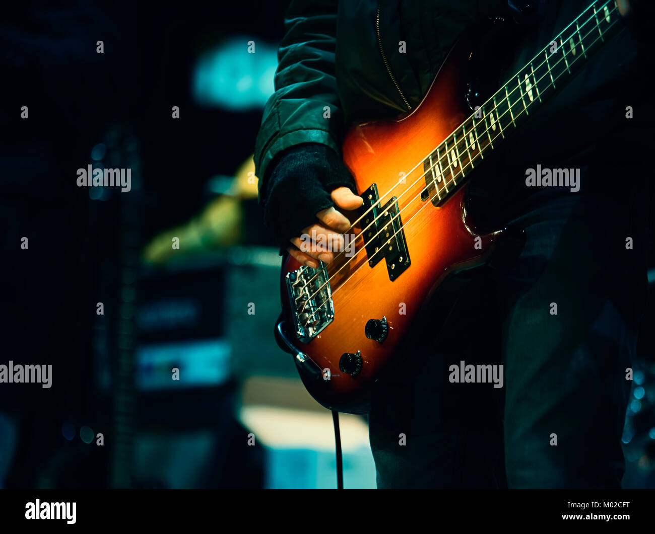 Guitarist playing guitar on concert Stock Photo - Alamy