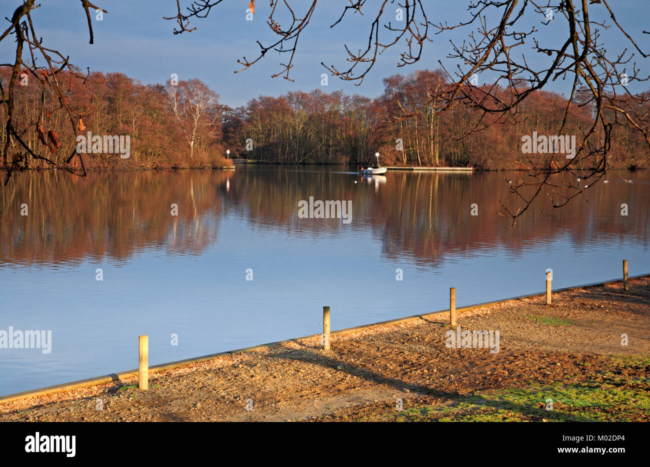 A view of Salhouse Broad in winter with boat mooring posts on the ...