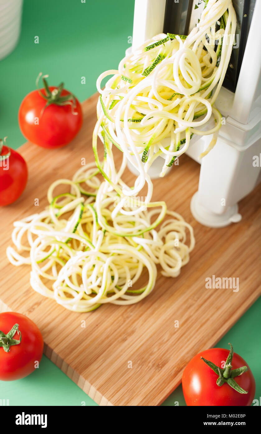 spiralizing courgette raw vegetable with spiralizer Stock Photo - Alamy