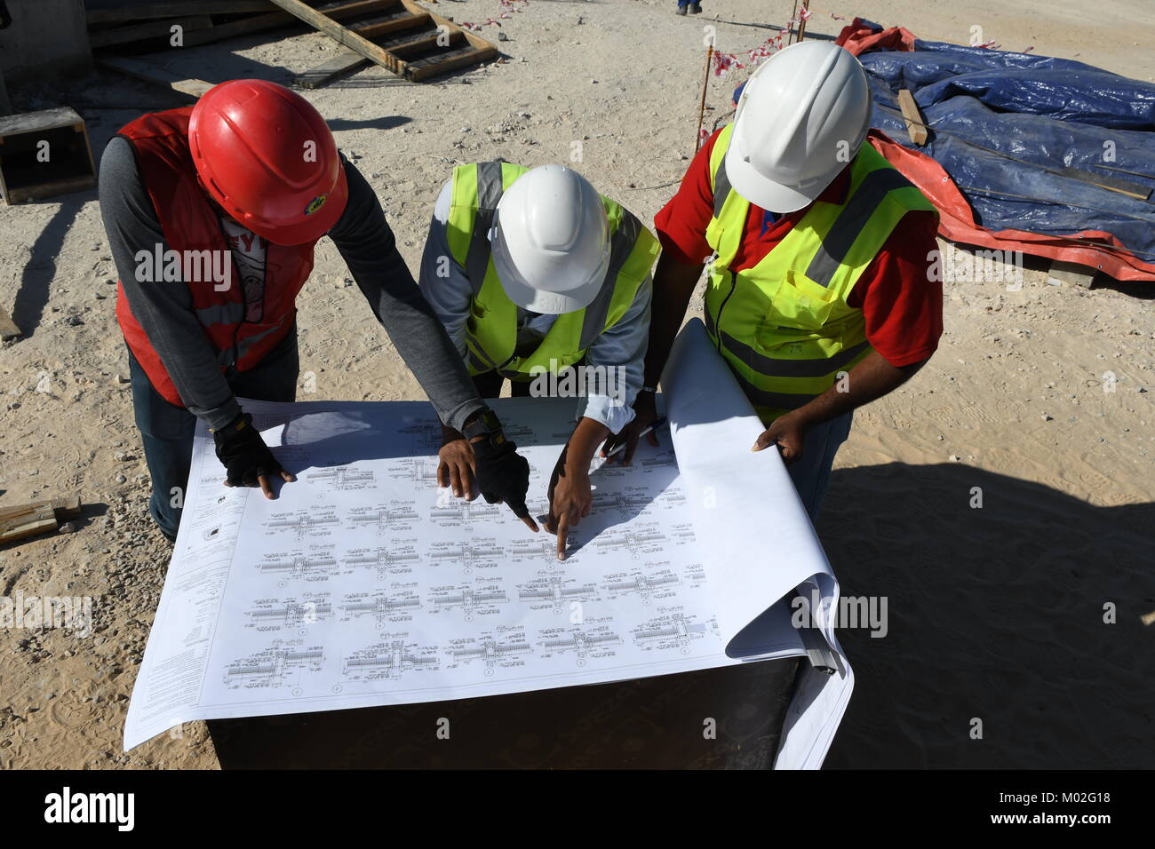 Indian Civil Engineers and foremen are working on the construction site ...