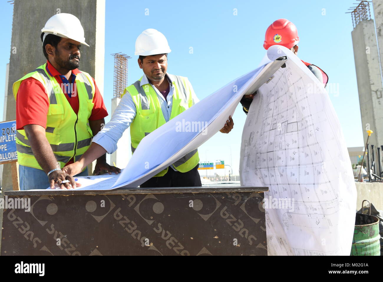 Indian Civil Engineers and foremen are working on the construction site ...