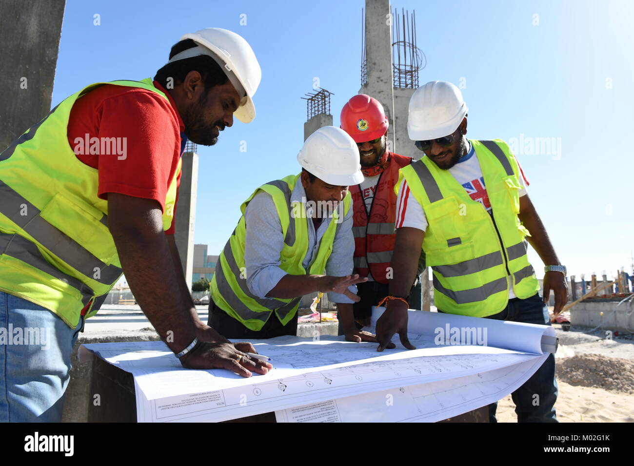 Indian Civil Engineers and foremen are working on the construction site ...