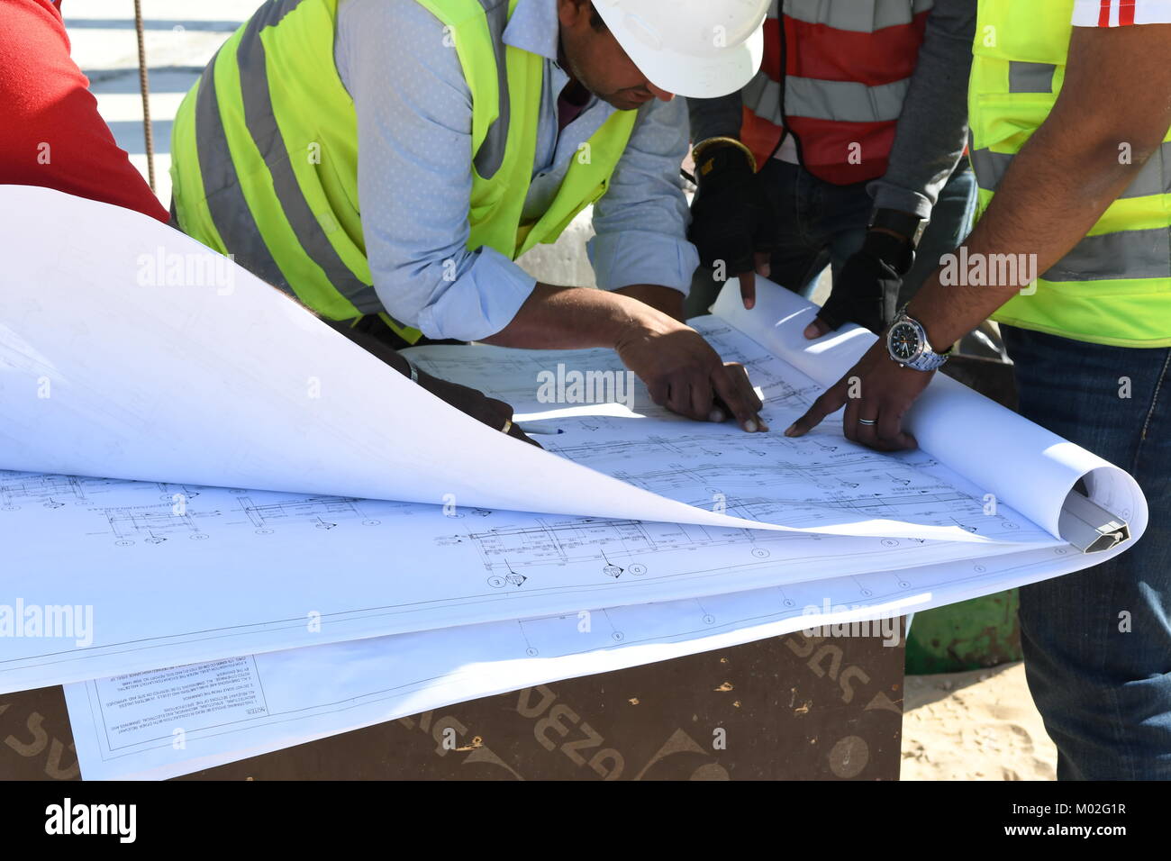 Indian Civil Engineers and foremen are working on the construction site ...