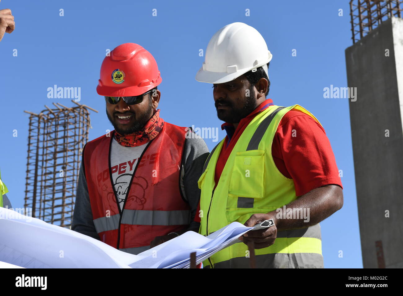 Indian Civil Engineers and foremen are working on the construction site ...