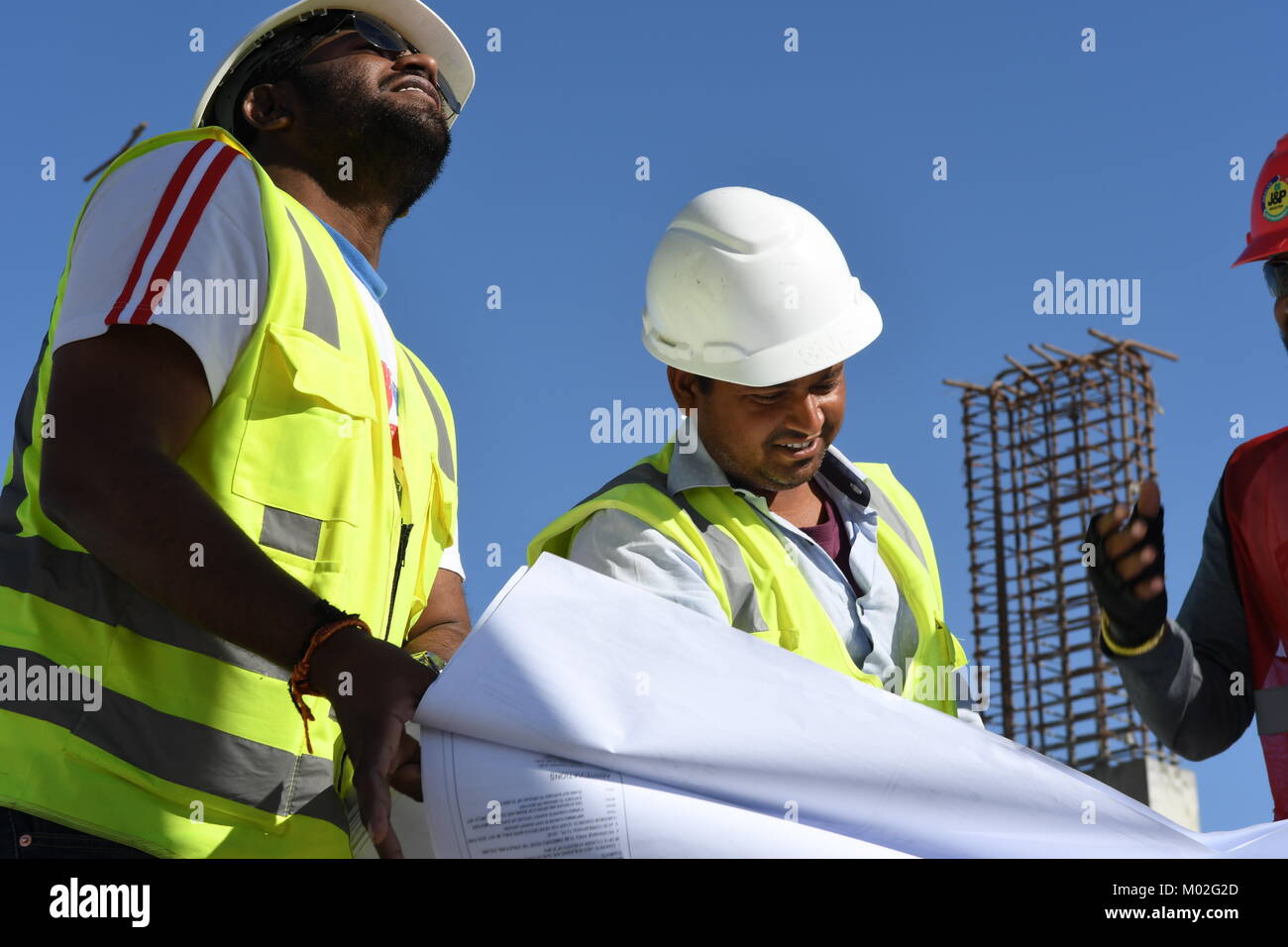 Indian Civil Engineers and foremen are working on the construction site ...