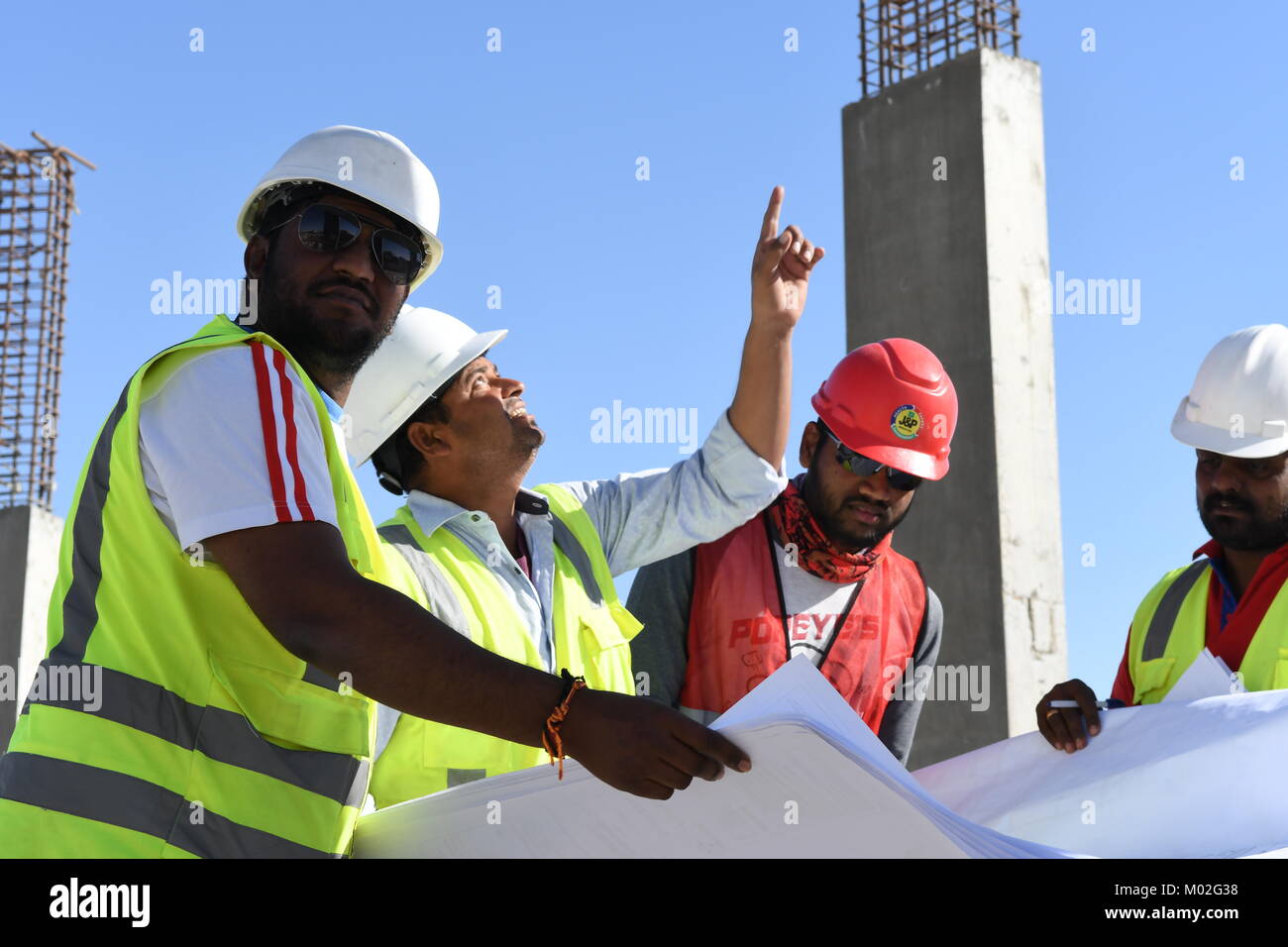 Indian Civil Engineers and foremen are working on the construction site ...