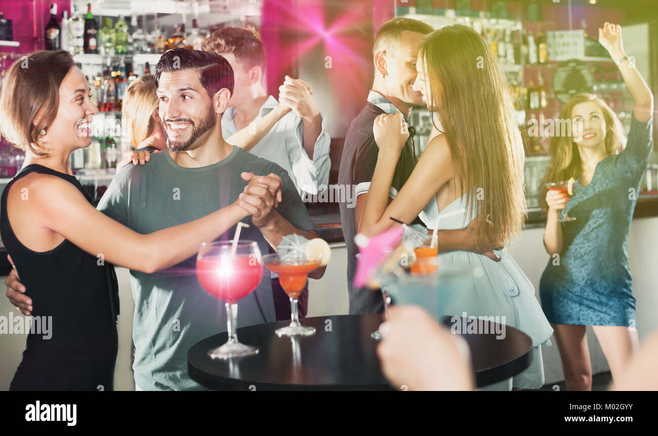 Female with man are dancing in pair on the party at a bar Stock Photo ...