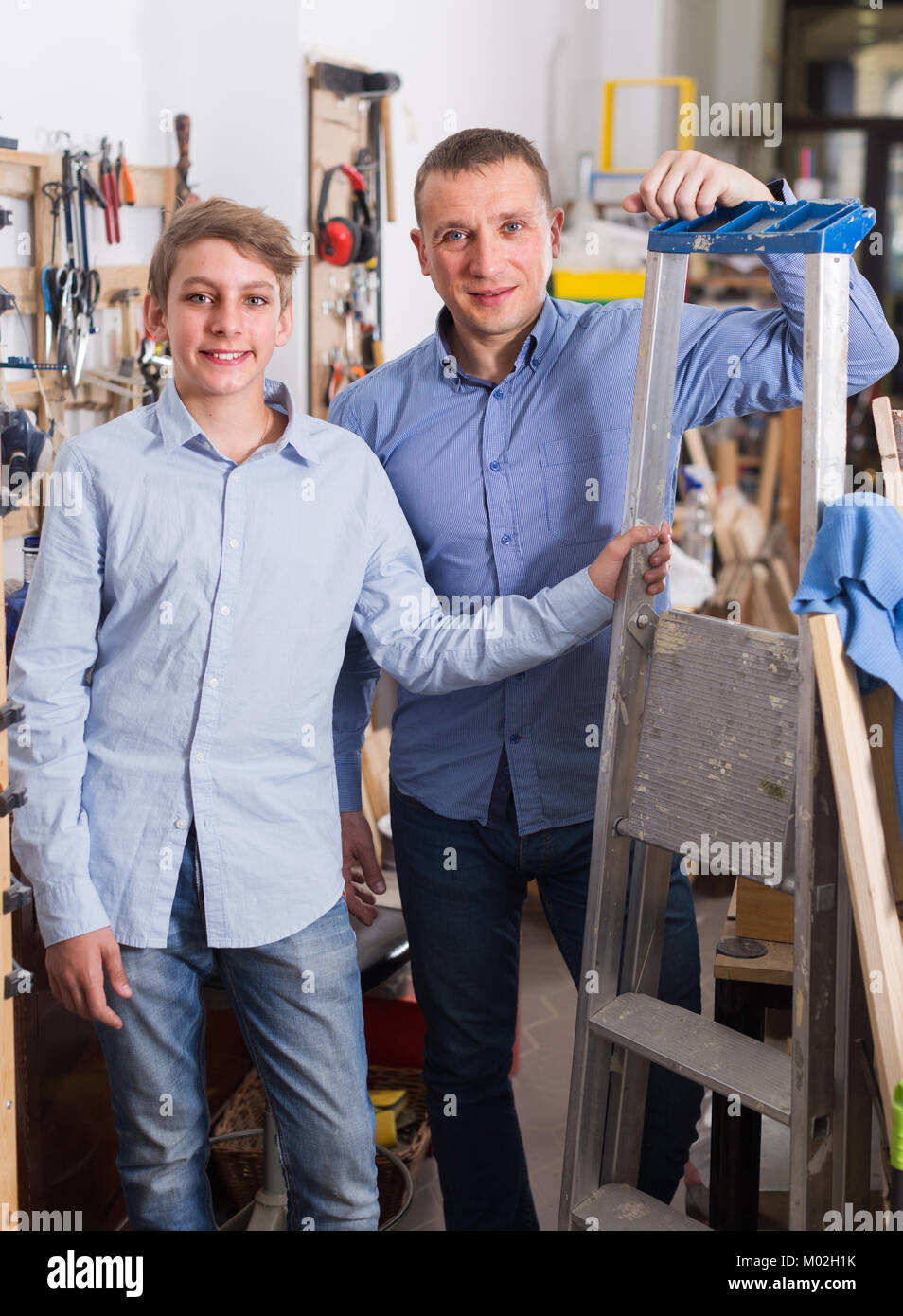 Portrait of positive russian adult father and son with stair in ...
