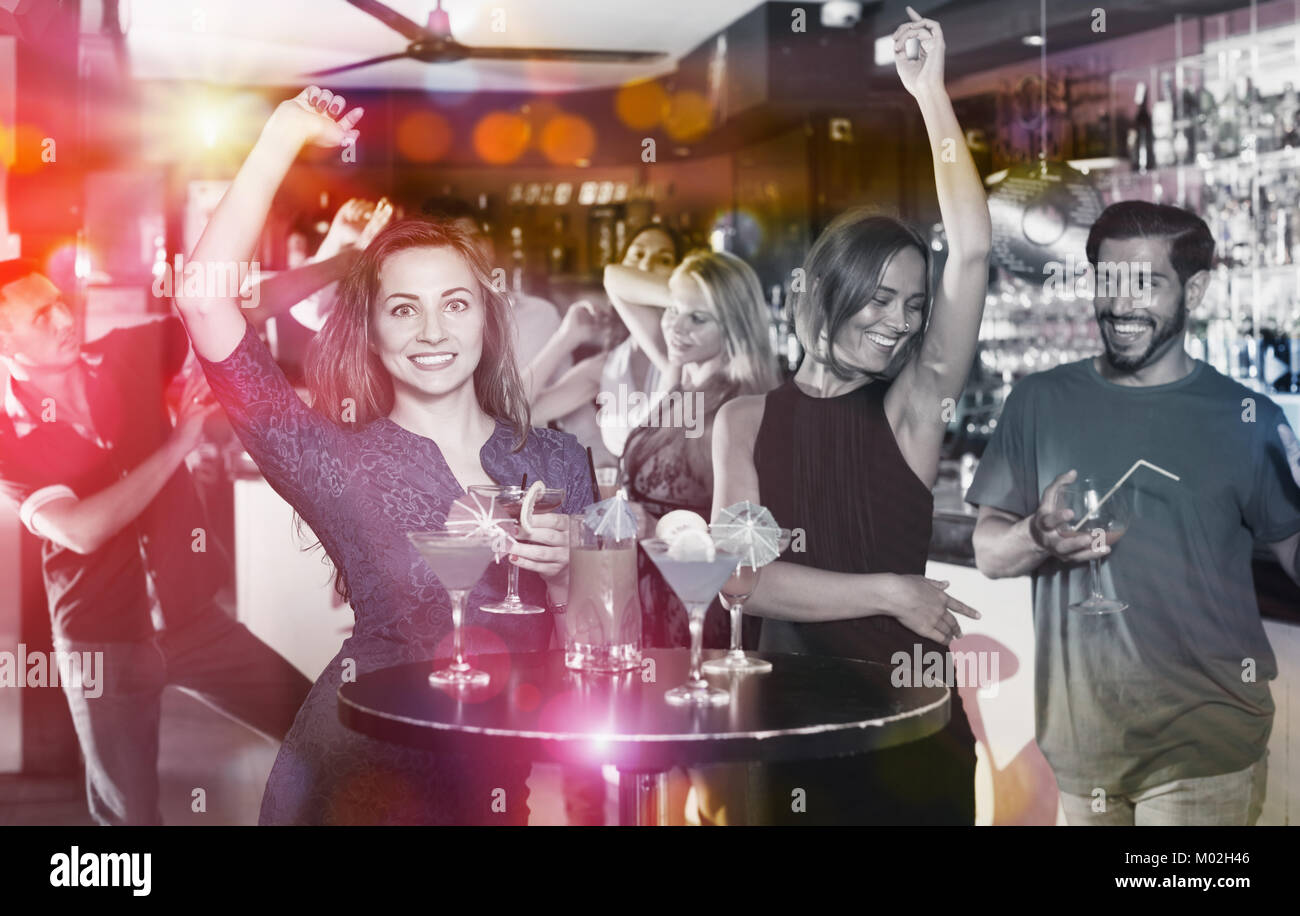 Young happy friends dancing on birthday party with cocktails Stock ...
