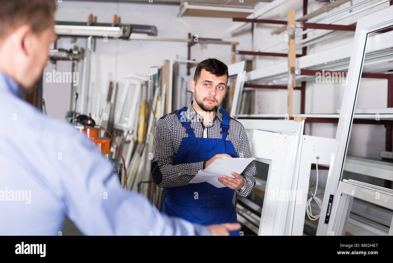 Workman is taking order from customer at factory Stock Photo - Alamy