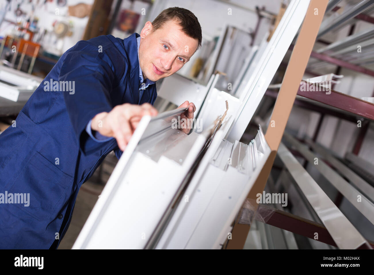 Ordinary workman inspecting PVC manufacturing output in workshop Stock ...