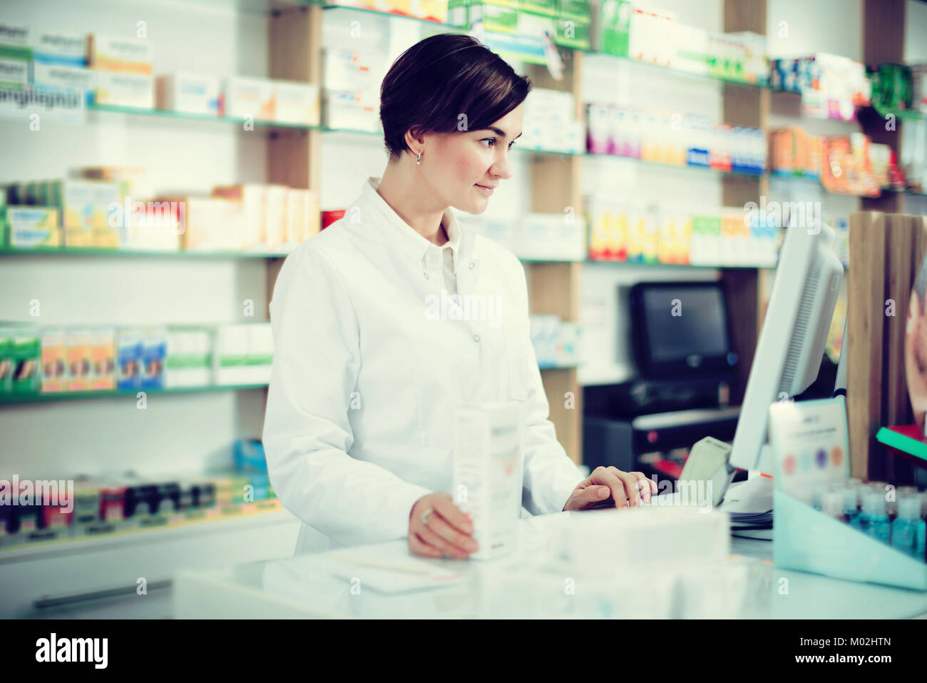 Portrait of positive woman pharmacist ready to assist in choosing at ...