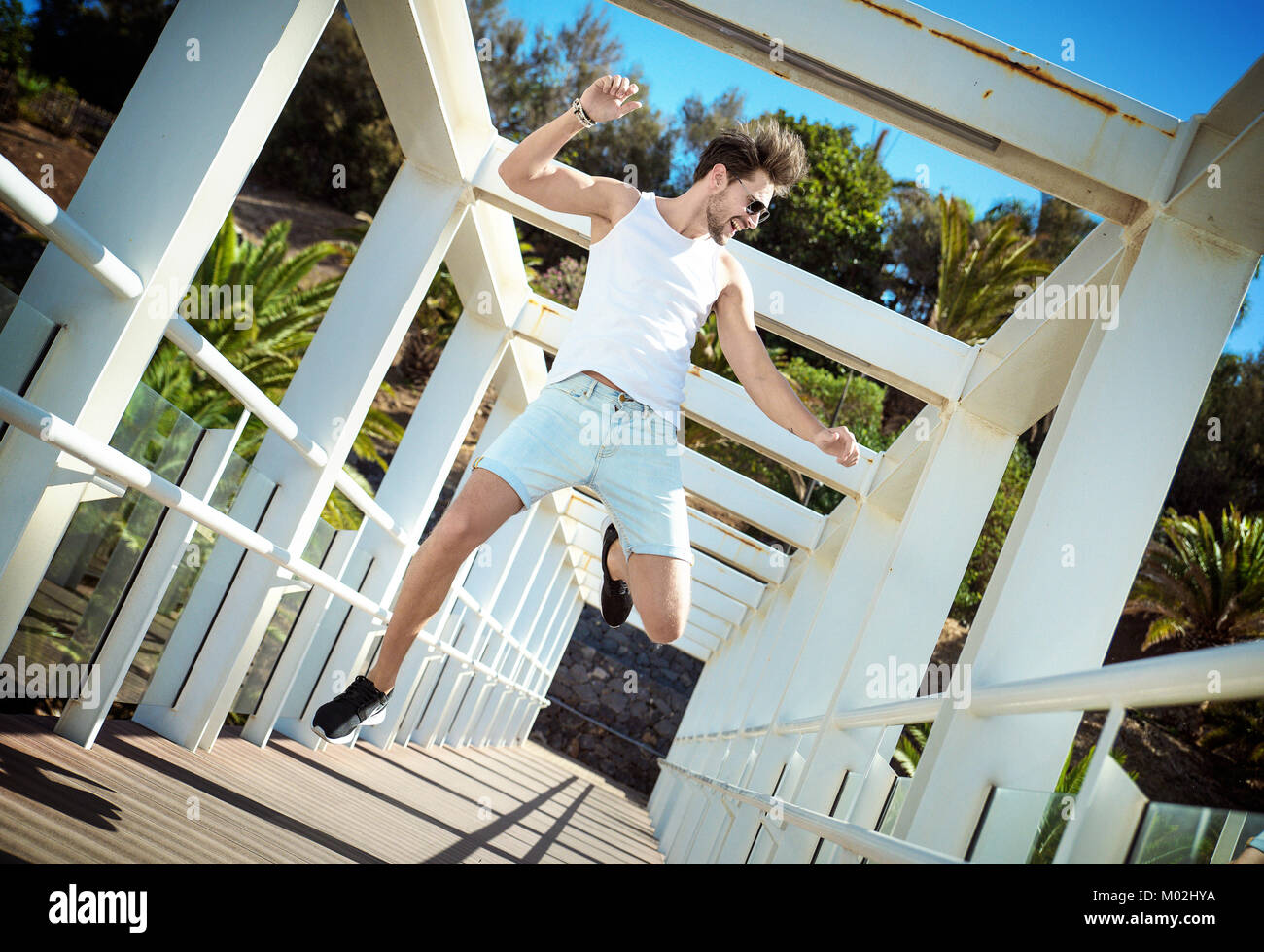 Handsome guy enjoying the summer in a tropical place Stock Photo - Alamy