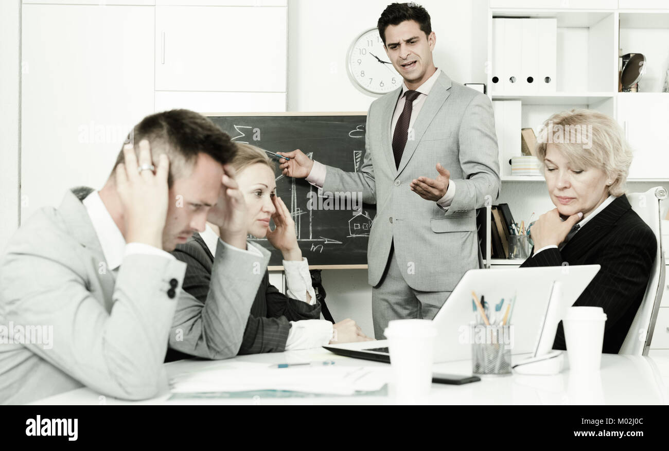 Angry boss blowing up his subordinates for mistakes in work Stock Photo ...