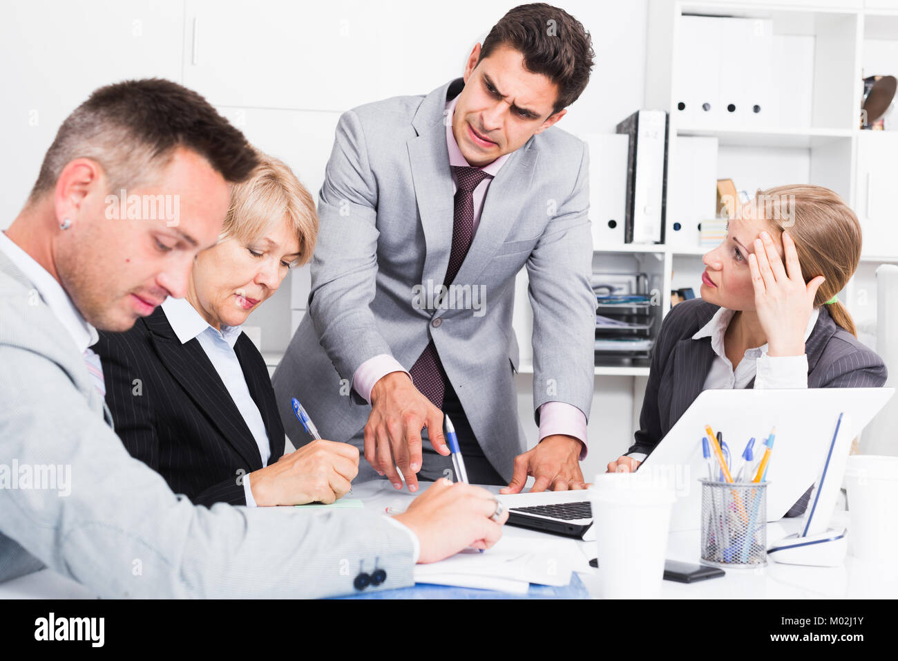 Businessman feeling angry to coworkers in office, pointing out mistakes ...