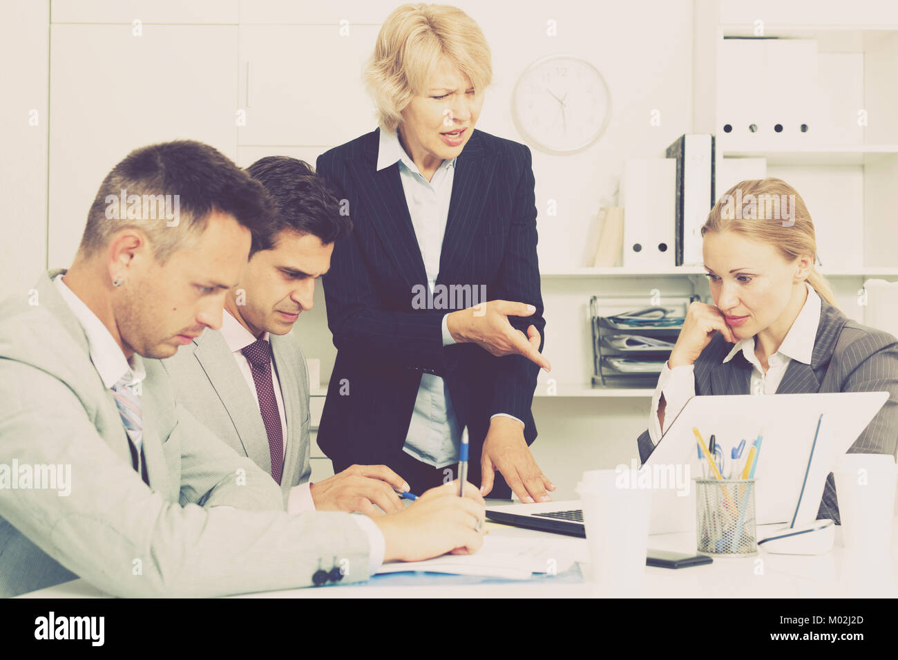 Business woman feeling angry to coworkers in office, pointing out ...