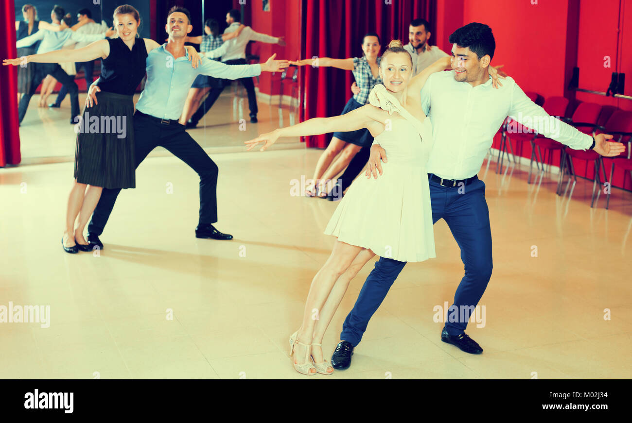 Young smiling people practicing passionate samba in dance class Stock ...