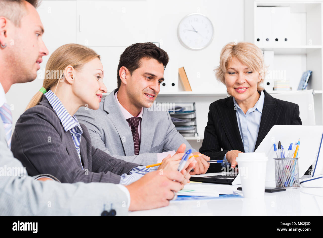 Group of confident business colleagues planning work at joint meeting ...