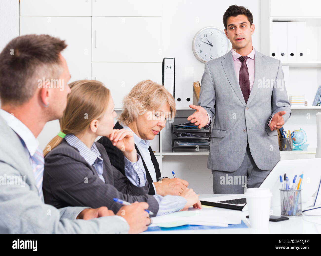 Chief gathering his managers for meeting at workplace Stock Photo - Alamy