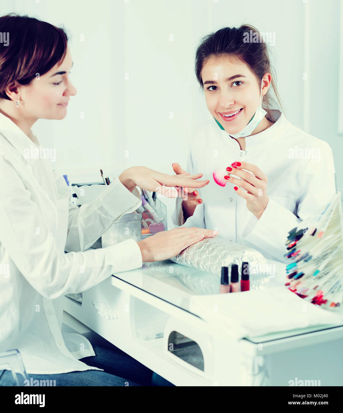 Adult woman client doing nails in nail salon in afternoon Stock Photo ...