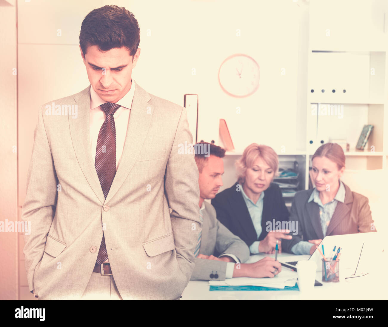 Business team tensely solving problems in office with upset man ...