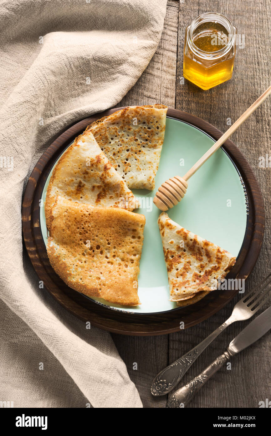 Tasty traditional russian breakfast of slapjack with honey on plate ...