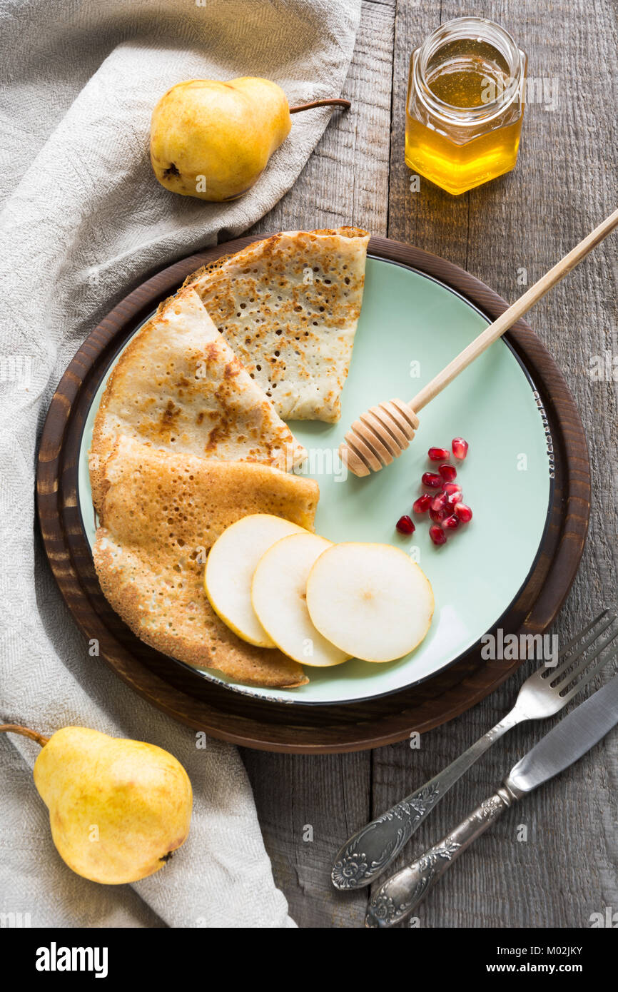 Tasty traditional russian breakfast of slapjack with honey on plate ...