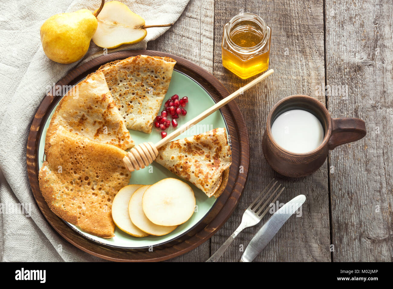 Tasty traditional russian breakfast of slapjack with honey on plate ...