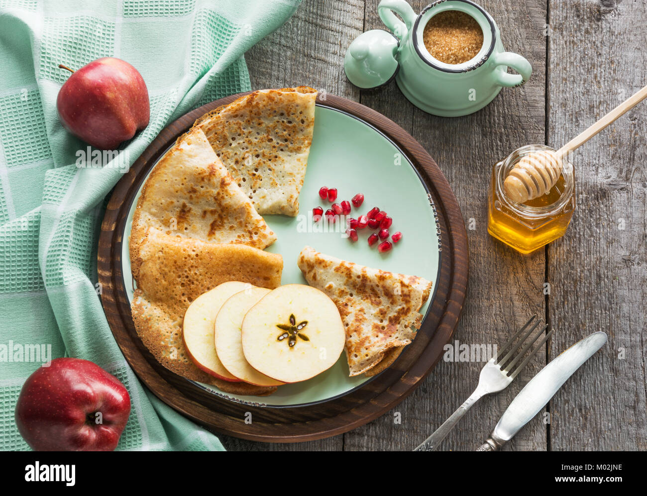 Tasty traditional russian breakfast of slapjack with honey on plate ...