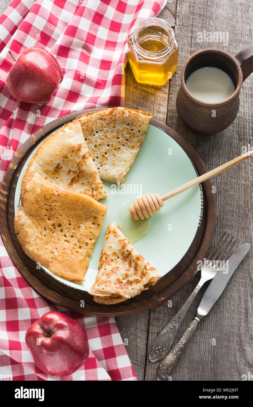 Tasty traditional russian breakfast of pancakes with honey on plate ...