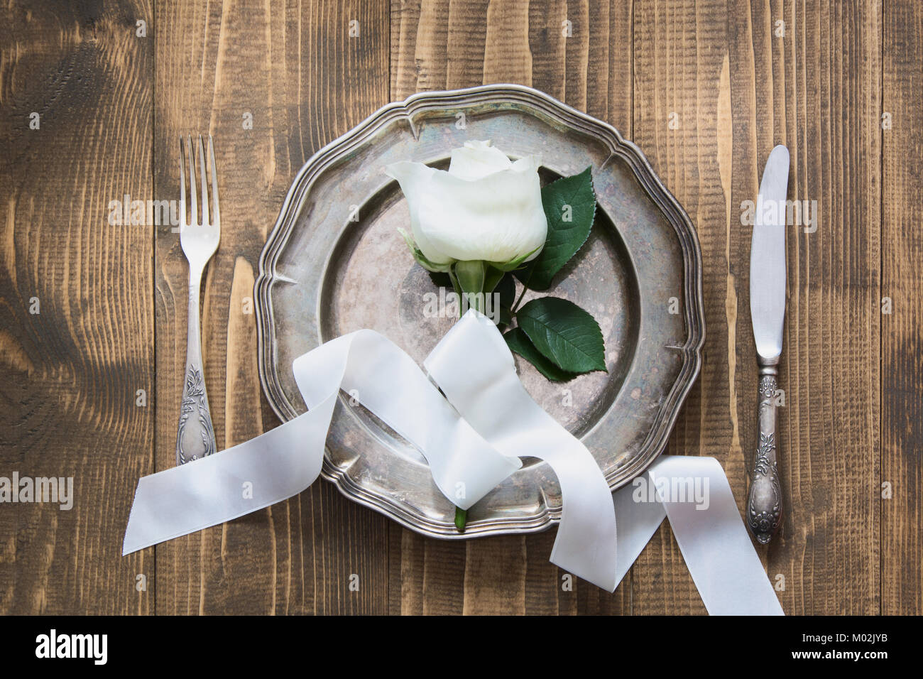 Romantic table setting with white rose as decor, vintage dishware ...