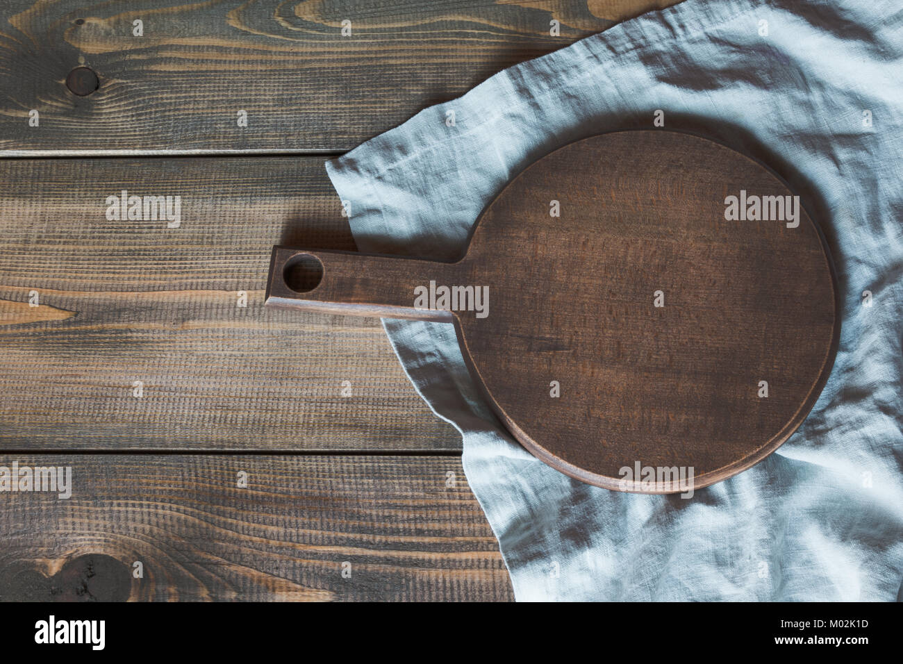 Rustic wooden cutting desk on wooden background. Top view and space for ...