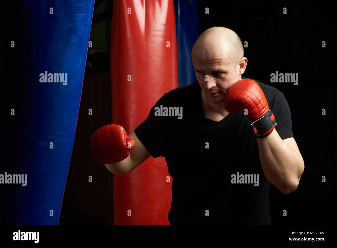 Man punching boxer bag. Boxing exercise of making punch Stock Photo - Alamy