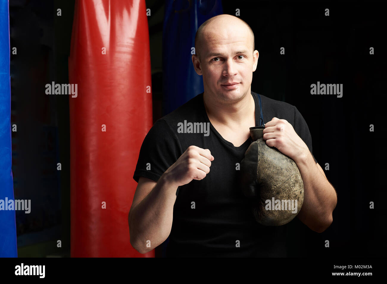 Boxing exercise concept. One young bold caucasian man hold fist up ...