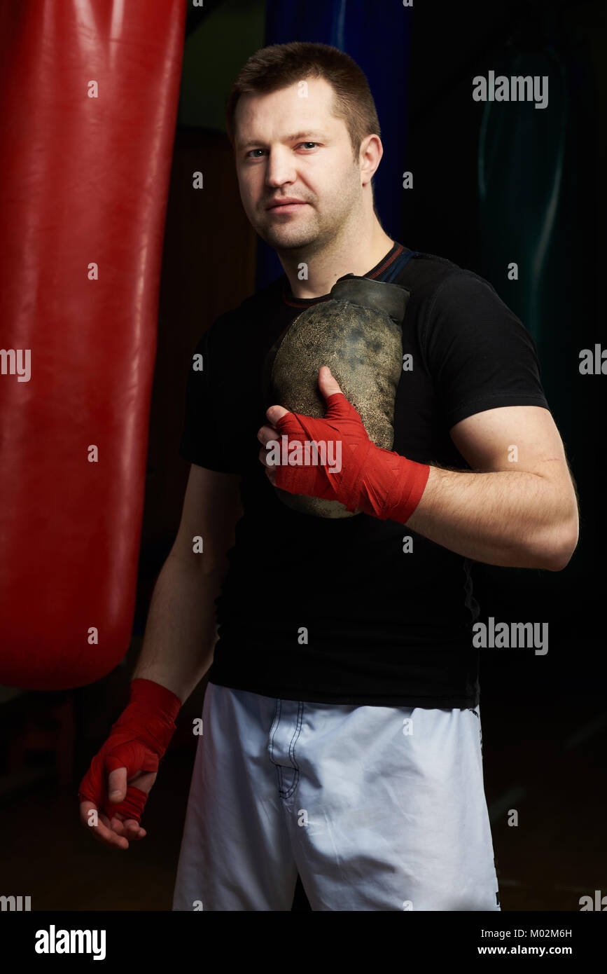 Handsome caucasian boxer man with grungy gloves on gym background Stock ...
