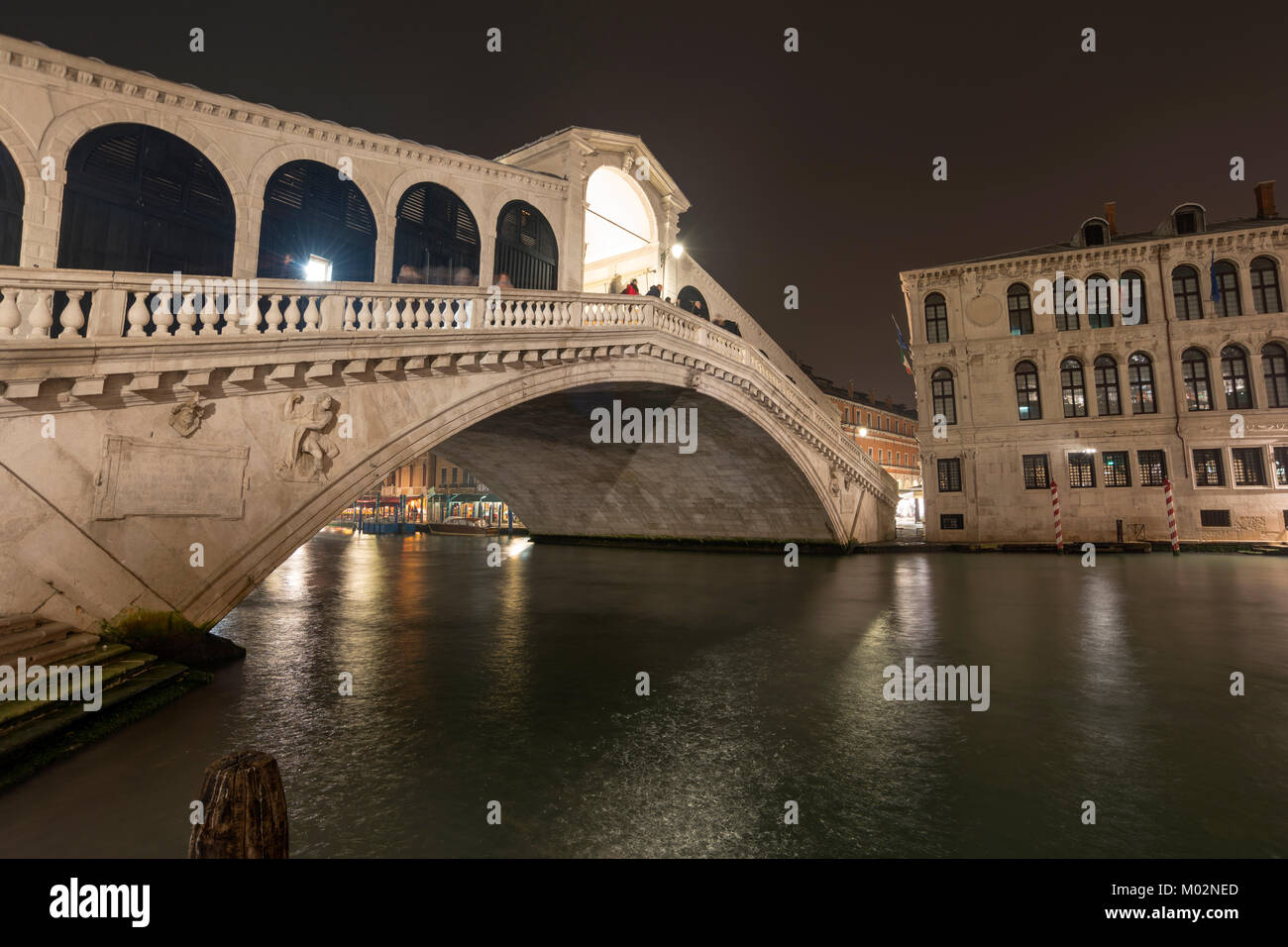 famous Rialto bridge in Venice by night Stock Photo - Alamy
