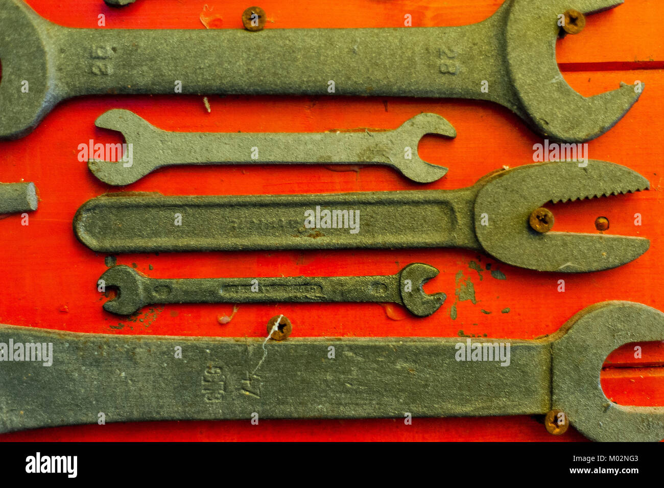 old and used english keys on red background Stock Photo - Alamy