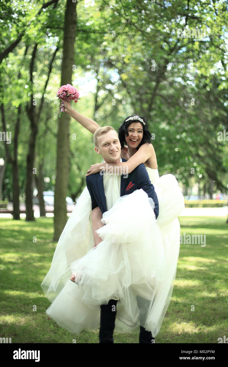 Groom carrying bride in arms hi-res stock photography and images - Alamy
