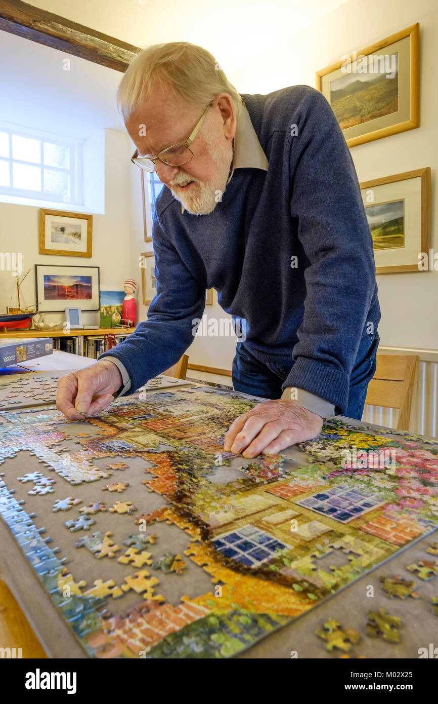OLDER MAN WORKING ON A JIGSAW UK Stock Photo - Alamy