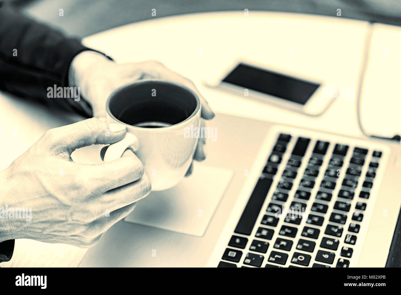 Black and white picture hands, coffee and laptop Stock Photo - Alamy