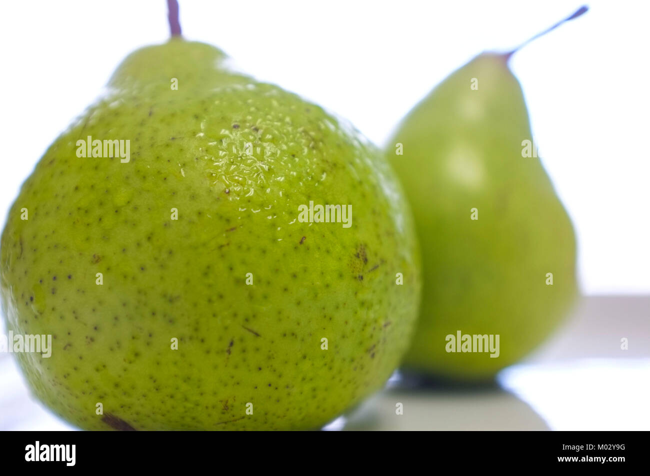 Two pears against a white background Stock Photo - Alamy