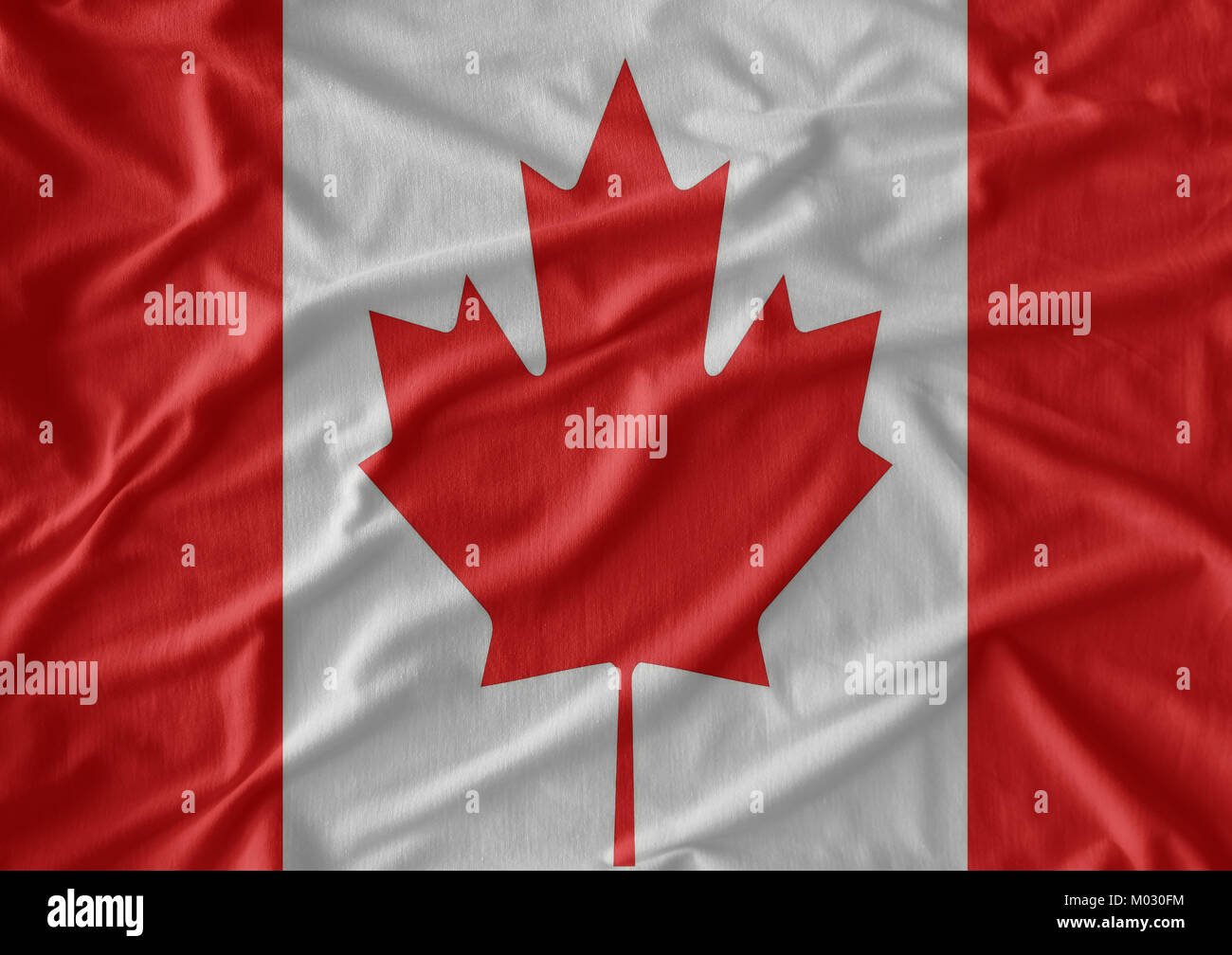 Canada flag on the fabric texture background Stock Photo - Alamy