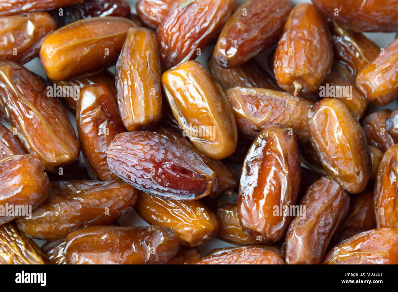 Bunch of dry date fruits forming a background Stock Photo - Alamy