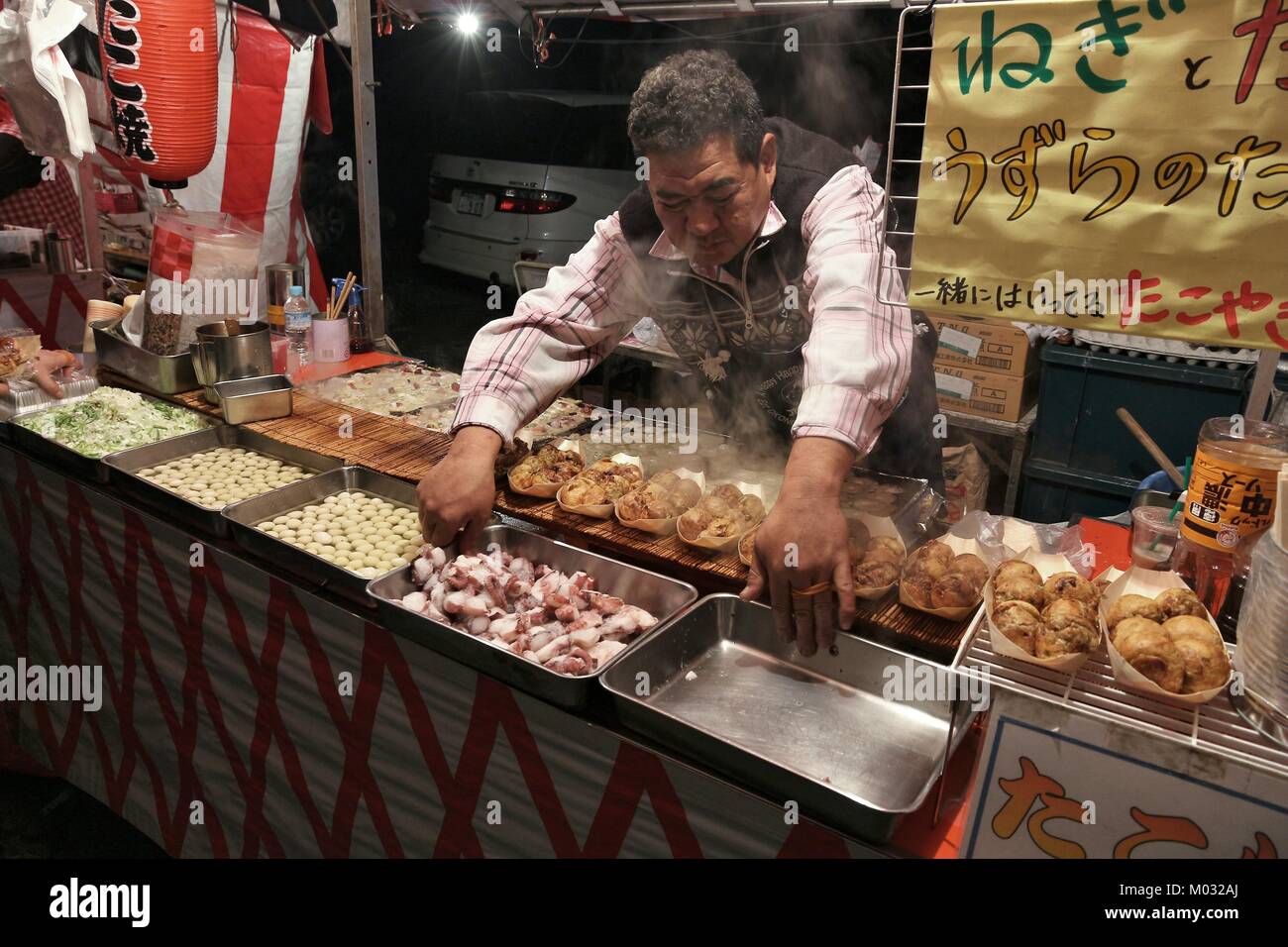 CHICHIBU, JAPAN - DECEMBER 3, 2016: Vendor prepares street food at ...