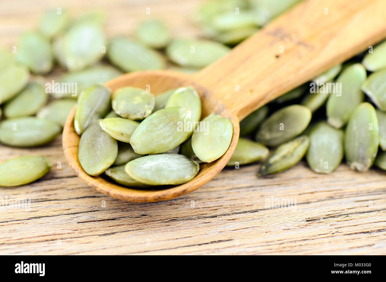 Pumpkin seed on wood background Stock Photo - Alamy